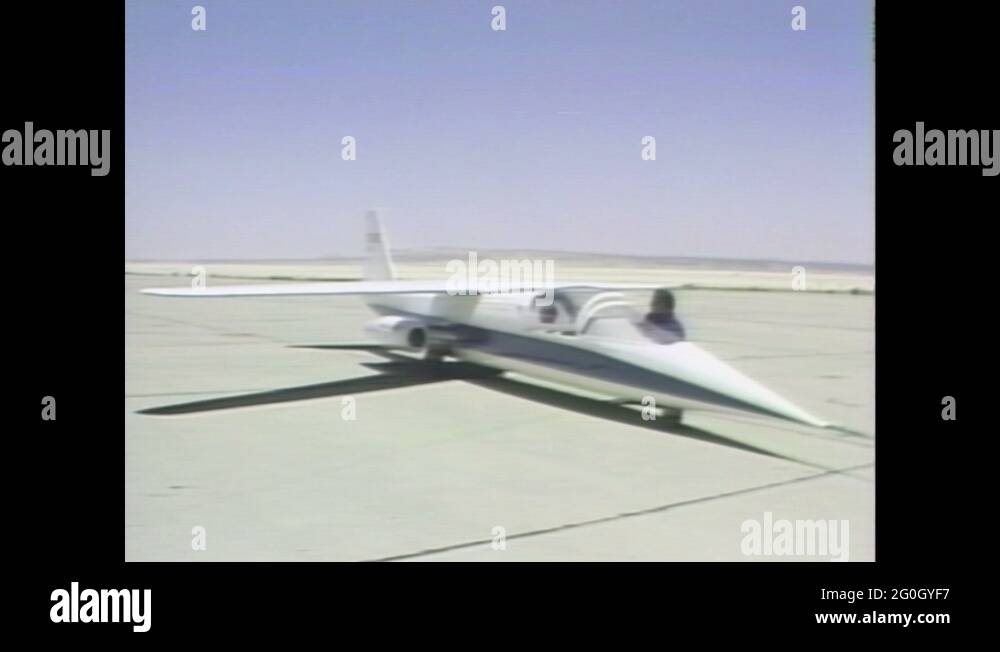 1970s: Scissor wing aircraft sits on runway. Wings on the scissor ...