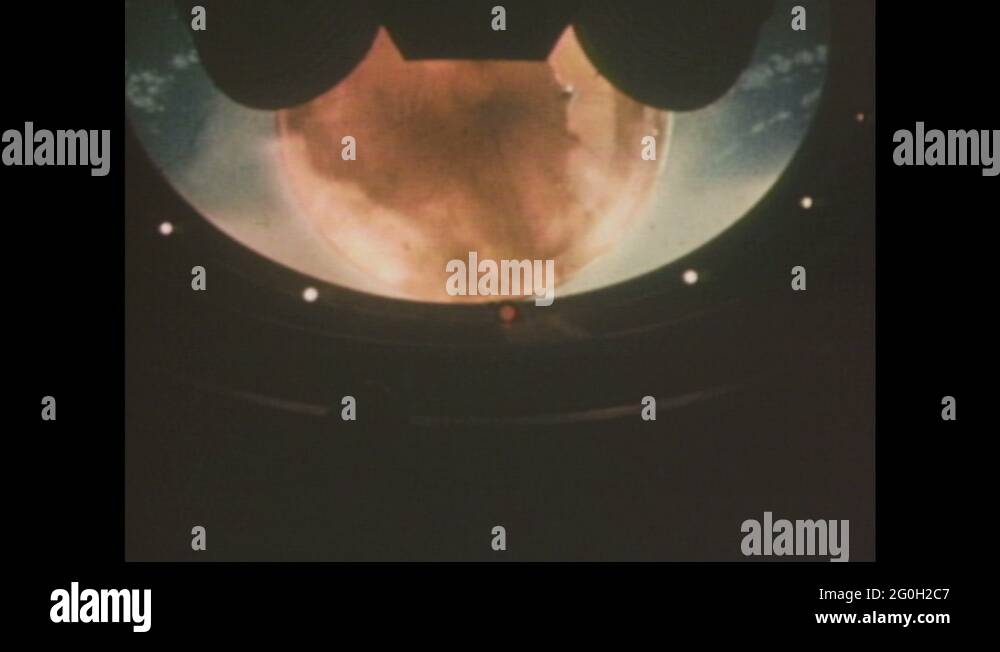 1960s: Stages of rocket fall away and tumble toward Earth. Text on ...