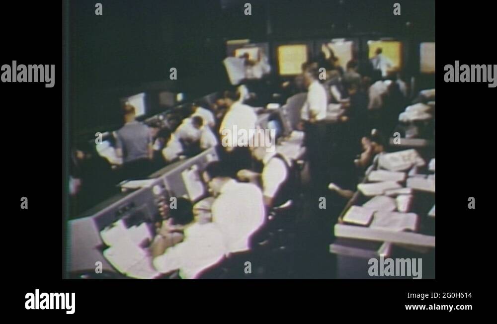 1960s: Men seated at work stations in NASA mission control room. Men ...