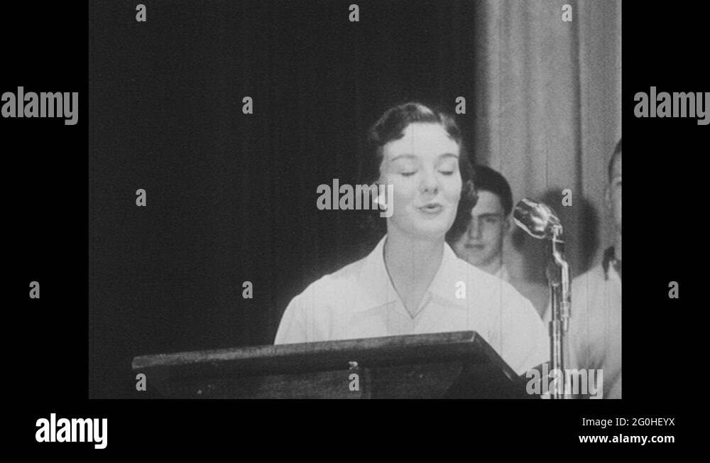 1950s: Teen girl introduces teen boy captain at podium. Basketball team ...