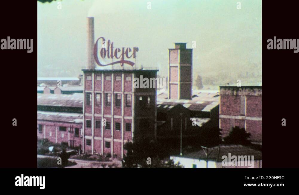 1960s: Sign atop large factory. Large textile mill. Large office ...