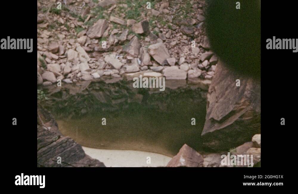 1940s: UNITED STATES: family walk across wobbly bridge. Girls walk ...