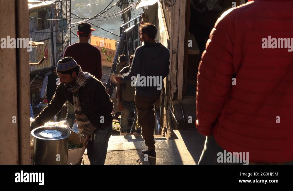 Two young Indian men walking down steps while laughing at camera Stock ...