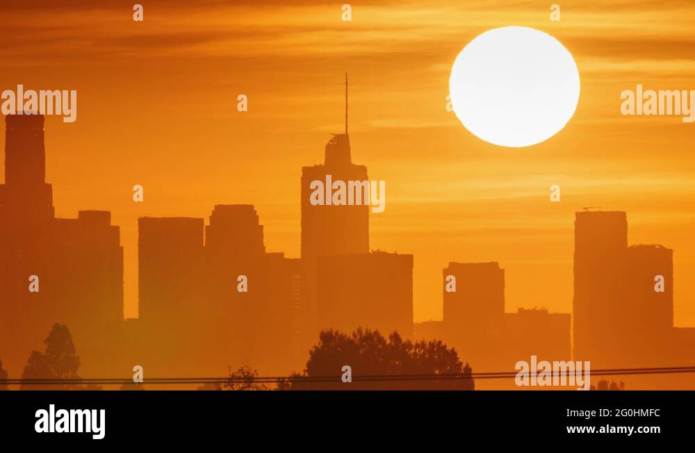 Sunrise sun rising over downtown Los Angeles skyscrapers zoom in on ...