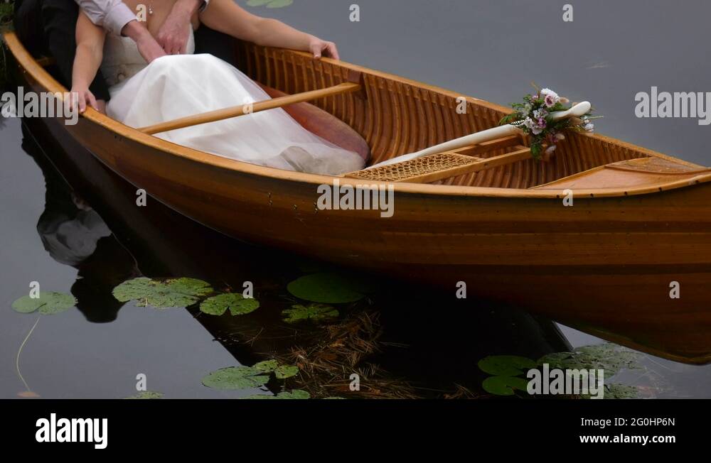 groom kisses bride in canoe pan from tip to newly weds 4k Stock Video ...