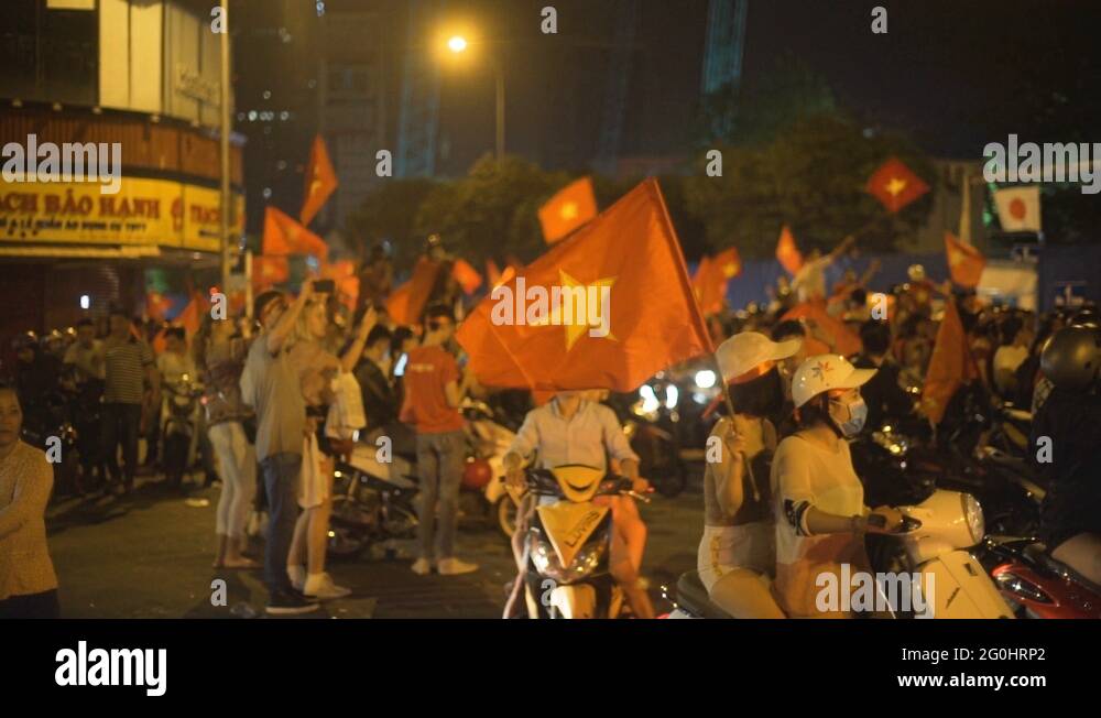 Football fans on vehiclese through crowds of fans celebrating in the ...