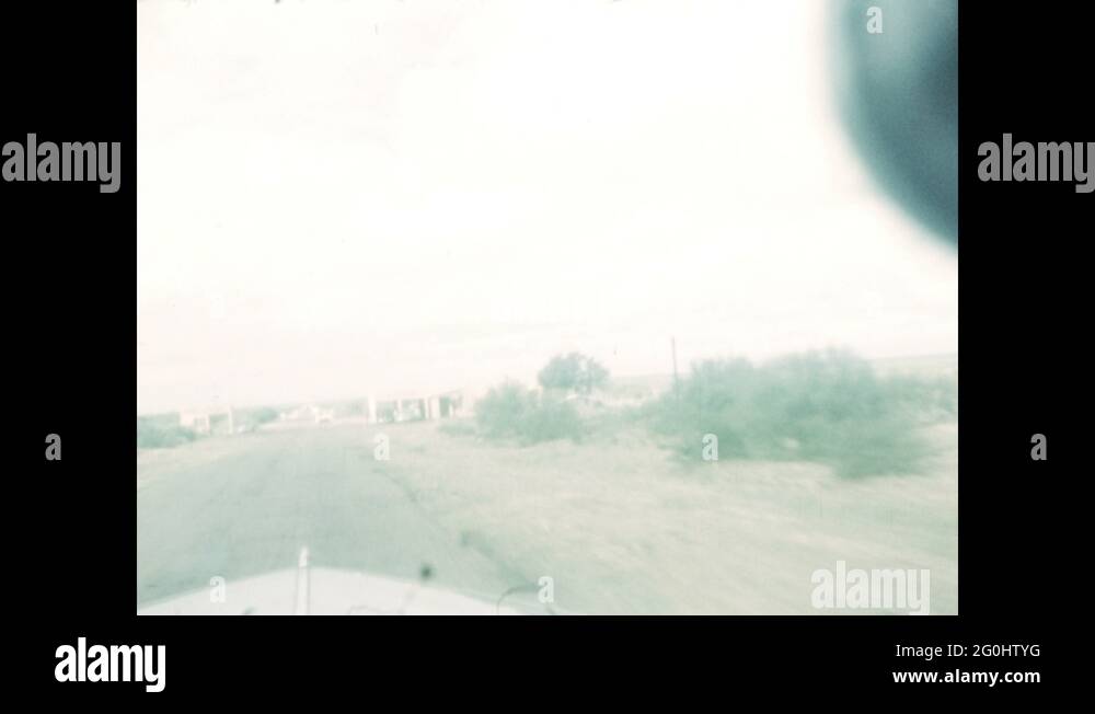 1940s: View from car, driving down road. Shots of pulling up to car ...