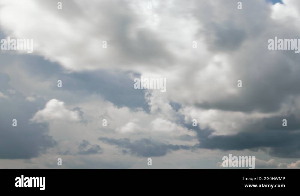 puffy and wooly clouds pass through sky forming rain clouds Stock Video ...