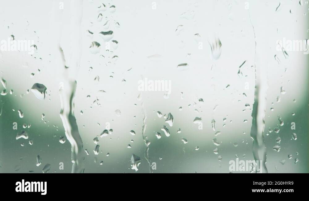 real rain drops sliding on window glass Stock Video Footage - Alamy