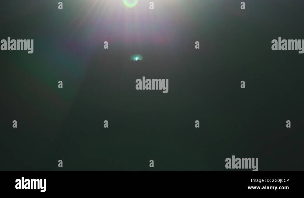 green lens flare over black background blinking Stock Video Footage - Alamy