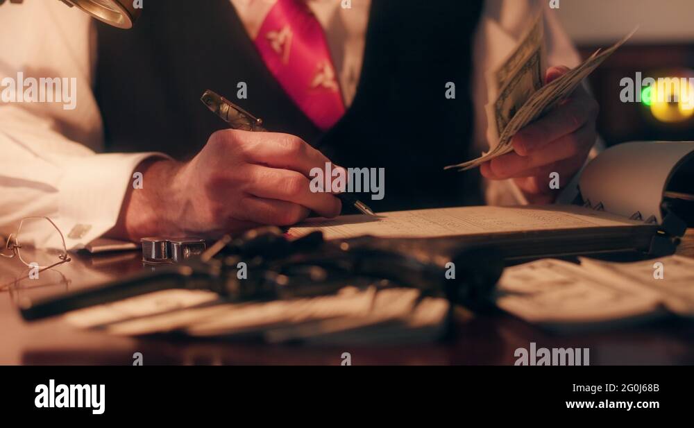 40s mob gangster counting money and writing in a ledger 4k Stock Video ...