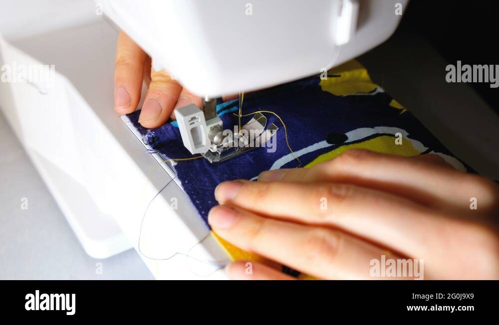 Woman sews on the sewing machine completes sewing close-up, 4k Stock ...