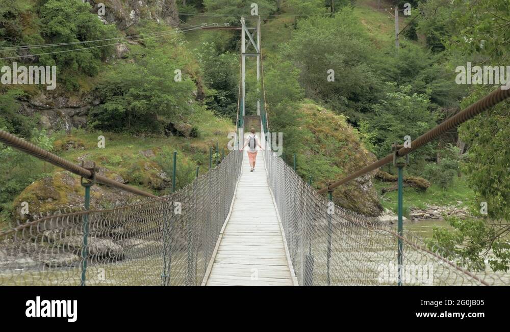 Young girl walks on the suspension bridge - Georgia Stock Video Footage ...