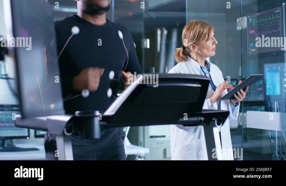 Monitor Shows EKG Reading of a Male Athlete Running on a Treadmill ...