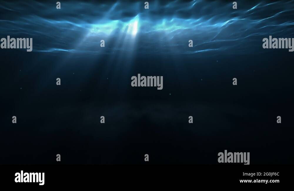 Underwater with floating plankton and sunray through water surface ...