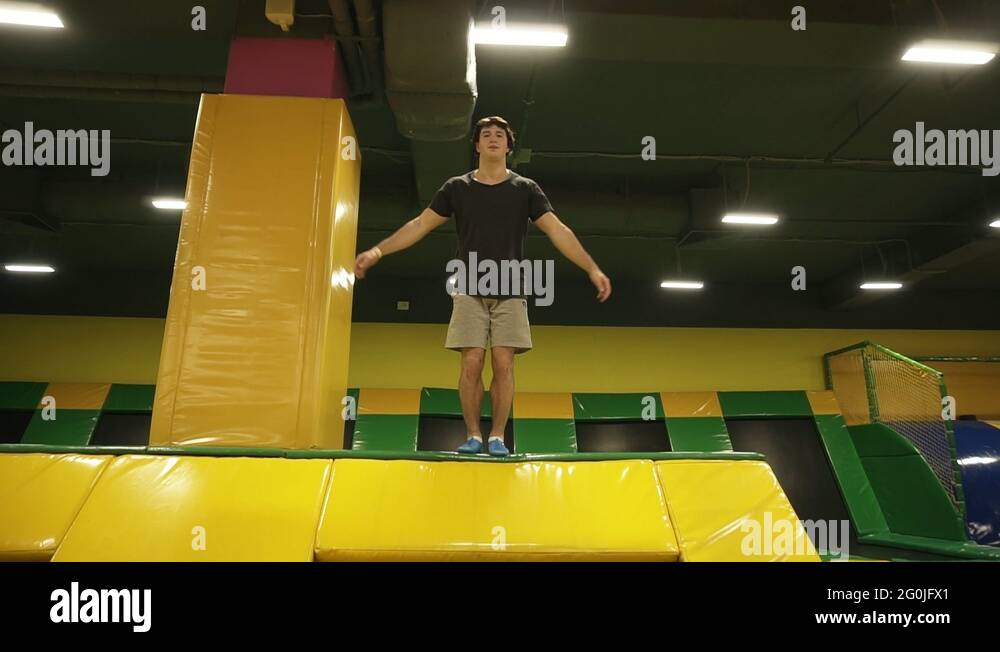 Frontside footage of a young male athletic gymnast perforing front ...