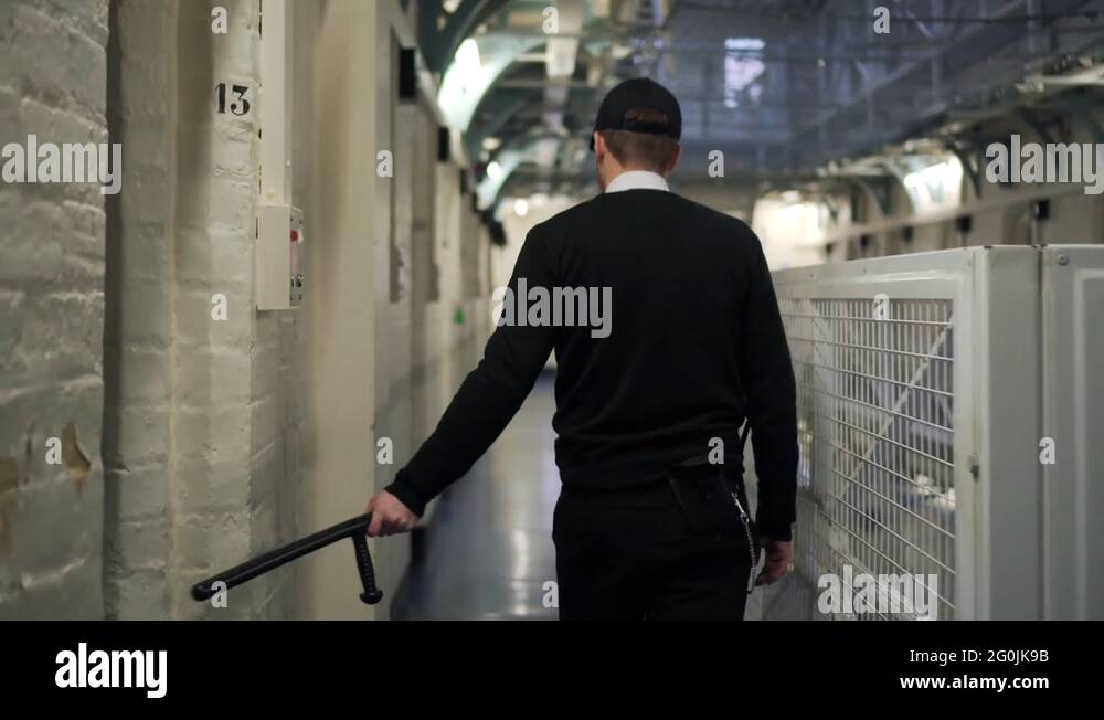 Prison Guard Walks Through Wing Block With Baton, Modern Incarceration ...