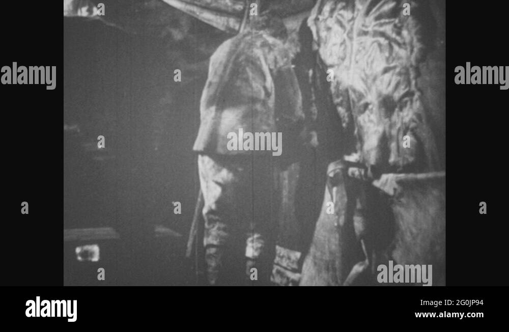 1940s: Man and child enter igloo, man closes door. Family sits inside ...