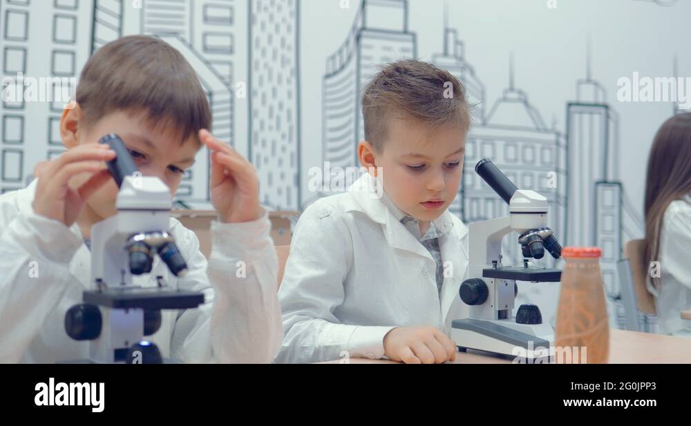 Pupil looking through microscope at the elementary school Stock Video ...