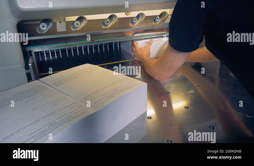 Industrial paper cutting machine cut extra paper from paper sheet Stock ...