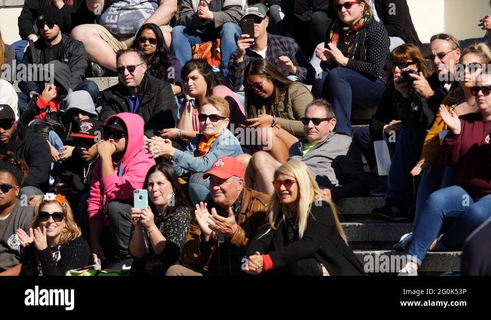 People sitting on steps outdoors clapping Stock Video Footage - Alamy