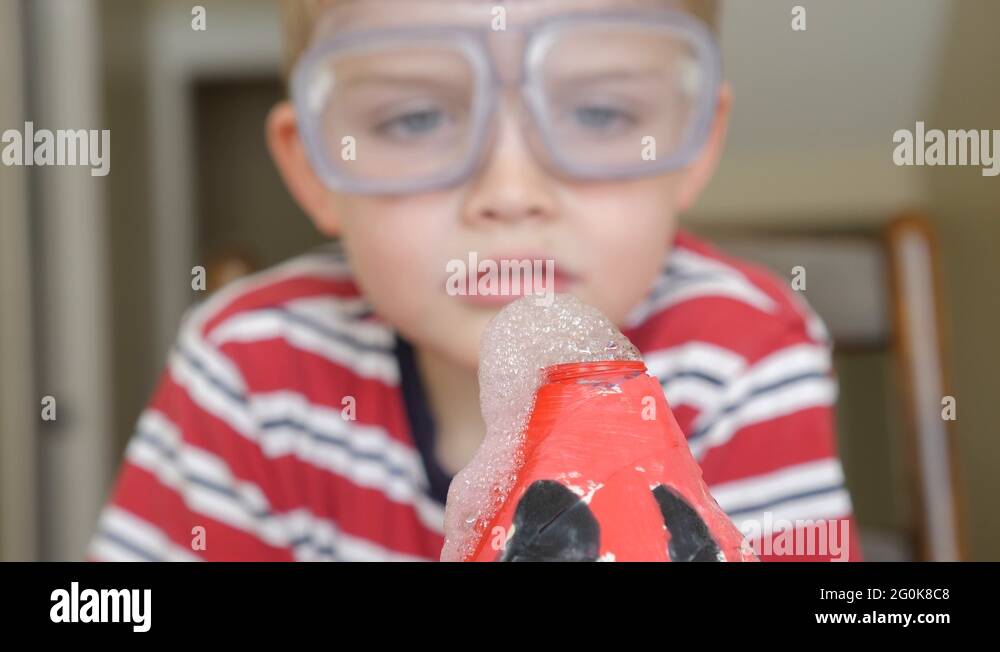 A cute little boy and his mother prepare to do a volcano science ...