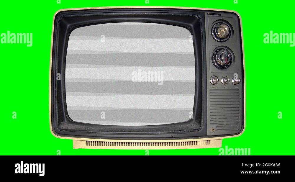 White noise static on a dusty old TV against a green screen background ...