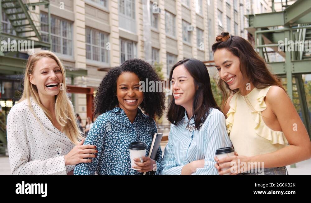 Female Work Friends Laughing Outside Their Workplace Stock Video