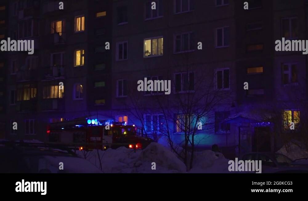 Fire Scene at night with fire trucks and flashing lights on the street ...