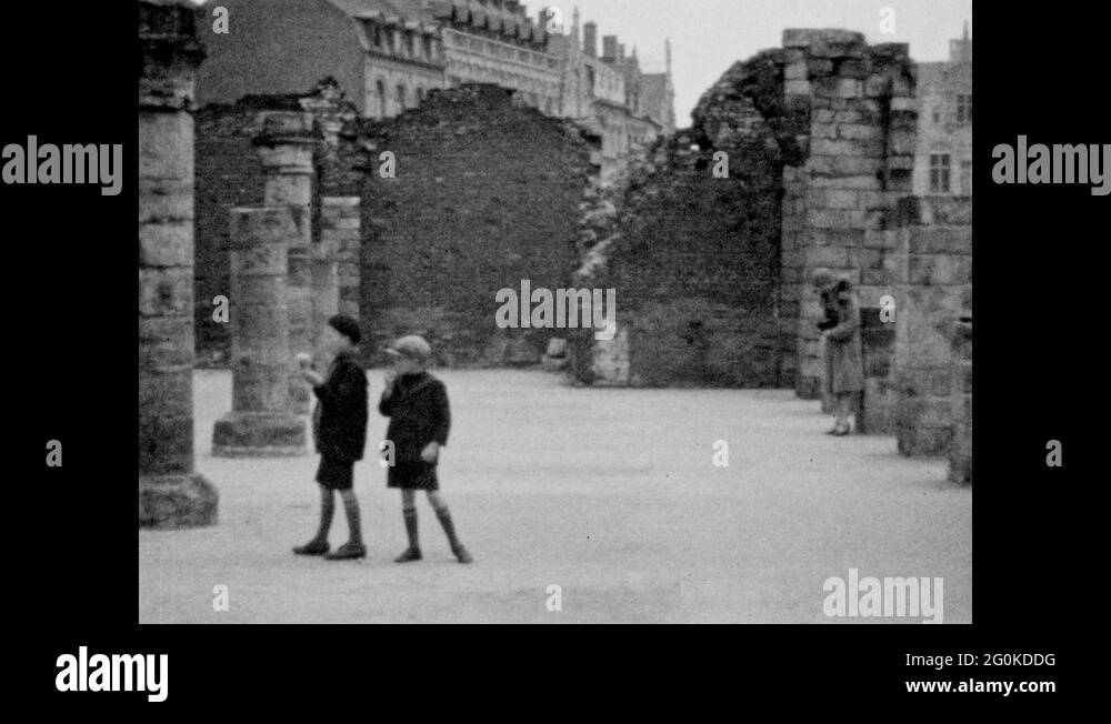 1920s: Scaffolding of building under construction. Two boys stand next ...