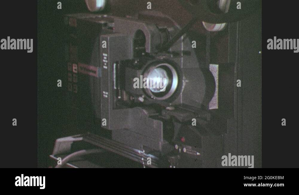 1970s: Projector beam switches off, hand removes the safe threader ...