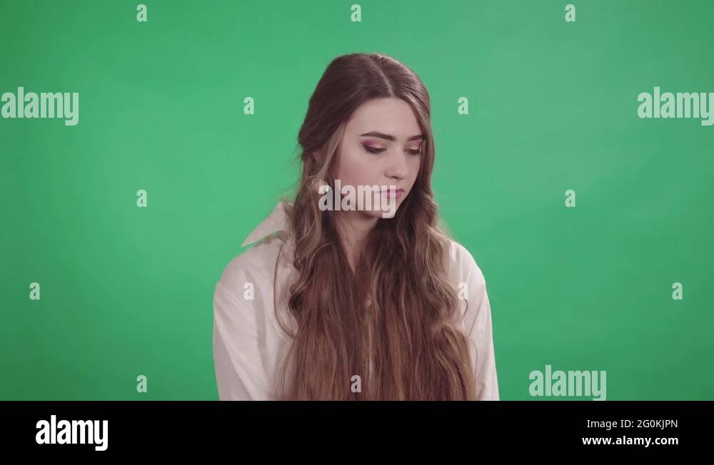 Girl shows emotions, actor play, sad and smile, green background Stock ...