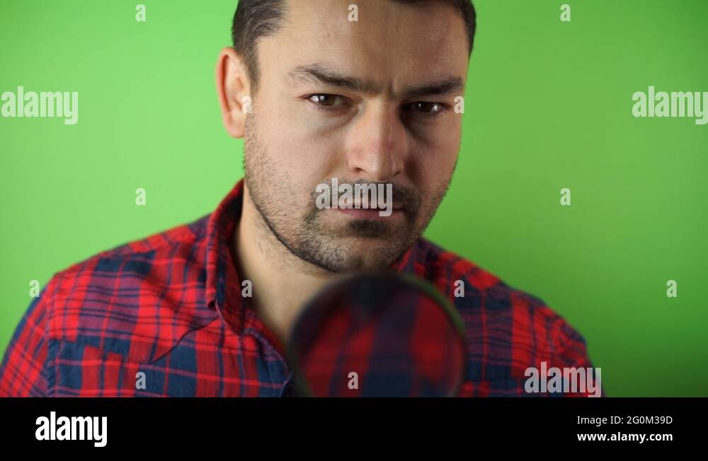 investigator looking with magnifying glass green screen background ...