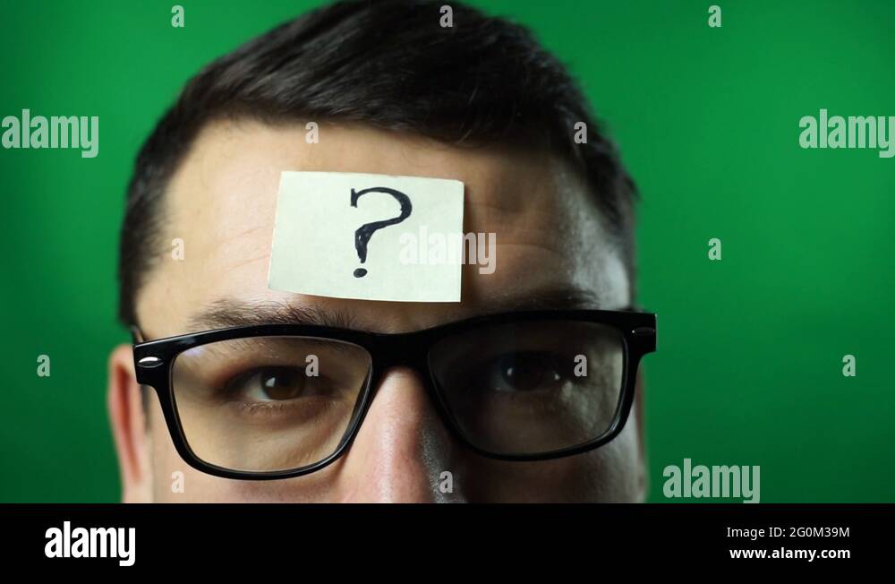 thinking man with question mark on gray wall background green screen ...