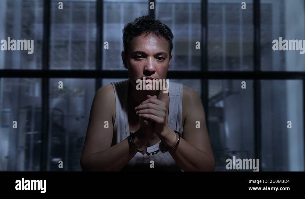 Female handcuffed at a table front view Stock Video Footage - Alamy