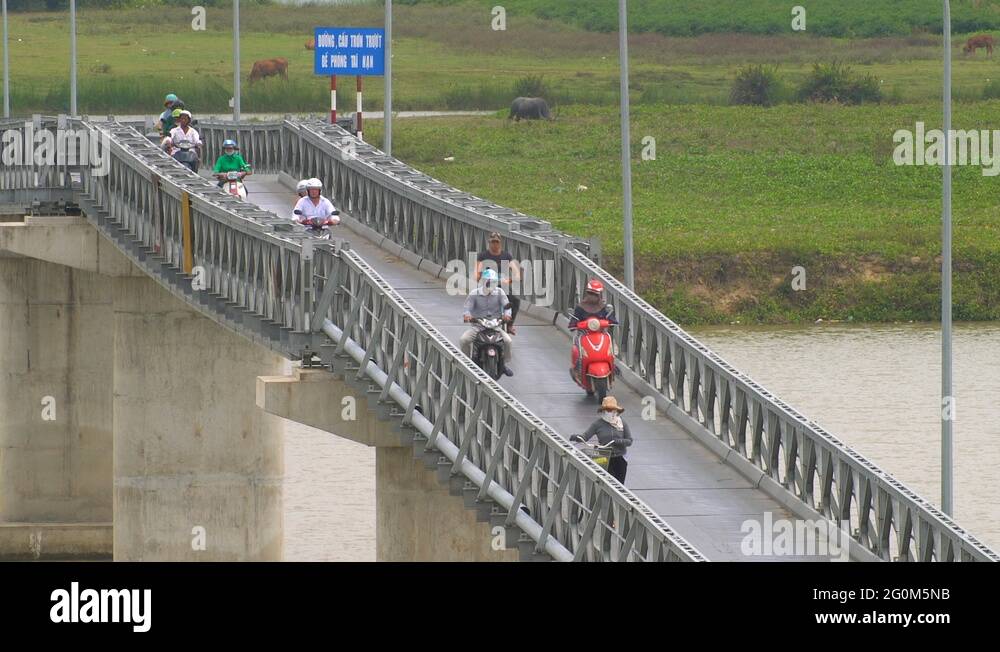 Zoom Out - Mopeds Pass Over a Narrow Bridge in Hoi An Vietnam Stock ...