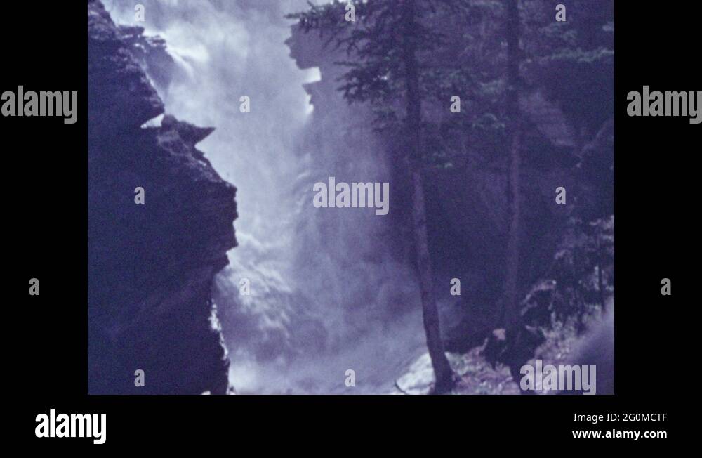 1950s: Tilt up waterfall. Pan across waterfall. High angle pan of ...