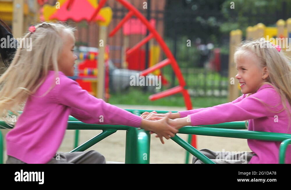 Twins on roundabout Stock Video Footage - Alamy