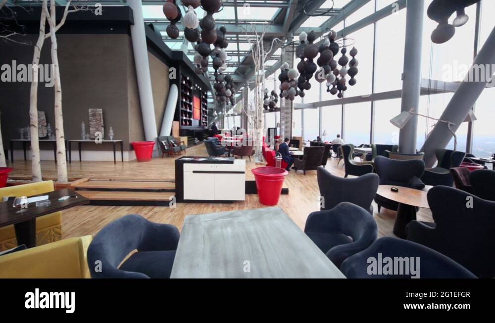 Several people sit at tables and waiter walks in restaurant Stock Video ...