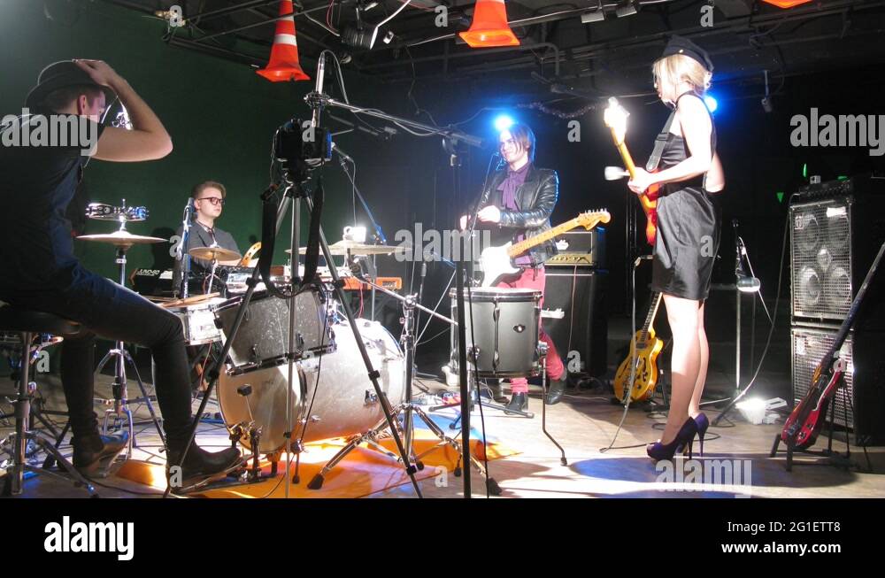 Band members rehearsing in studio stage with spotlights and sing Stock ...