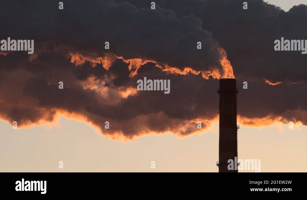 Smoke stack on sunset sky background Stock Video Footage - Alamy