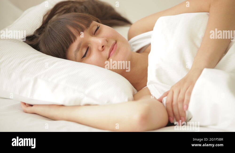 Charming girl sleeping in bed waking up and smiling Stock Video Footage ...