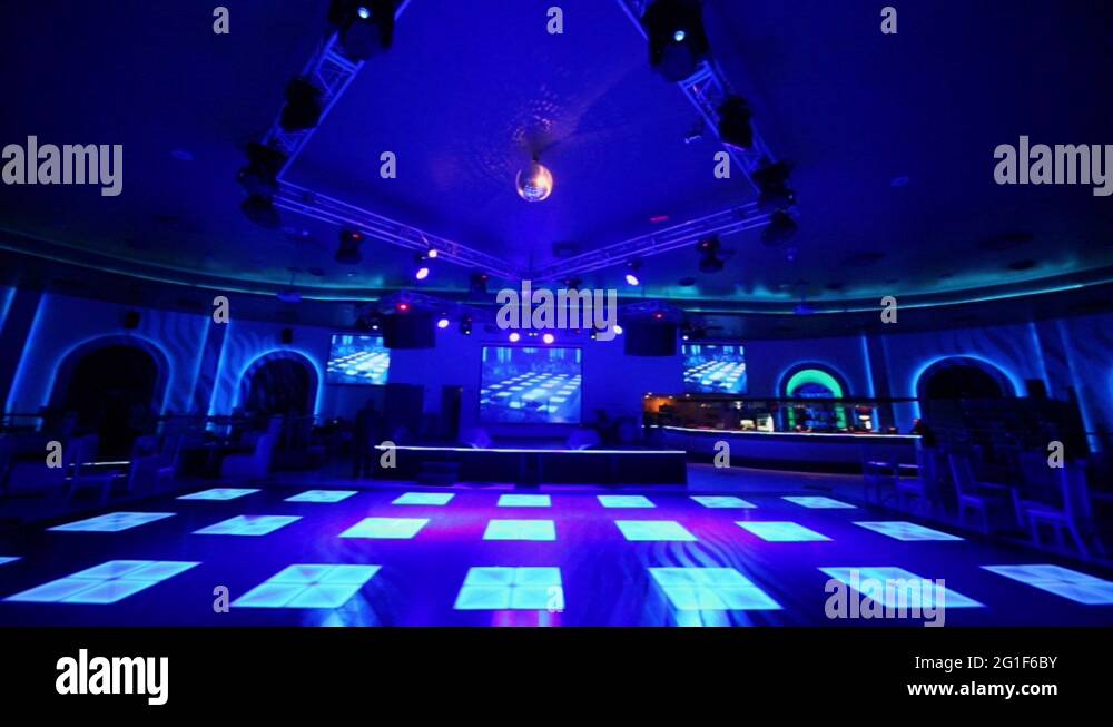 Waiter walks in club with dance floor near stage and bar Stock Video ...