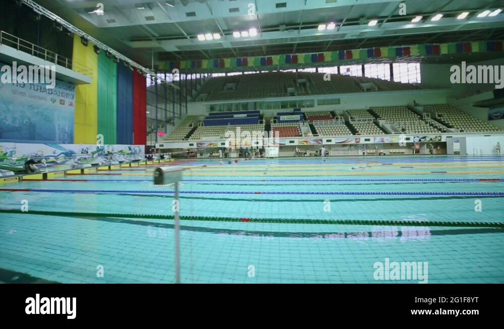 Several people swim by tracks in pool at Olympic Sports complex Stock ...