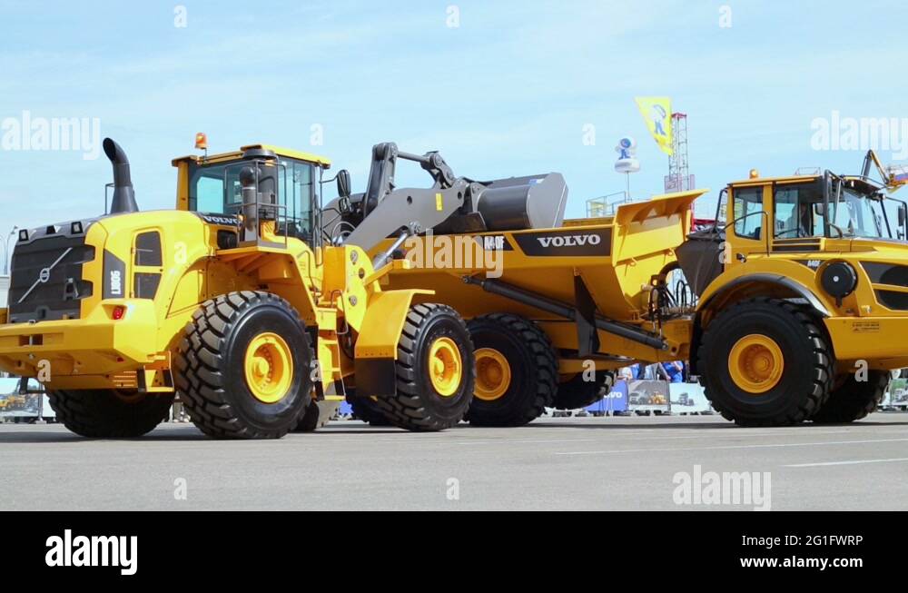 Loader loads articulated hauler VOLVO at Exhibition Stock Video Footage ...