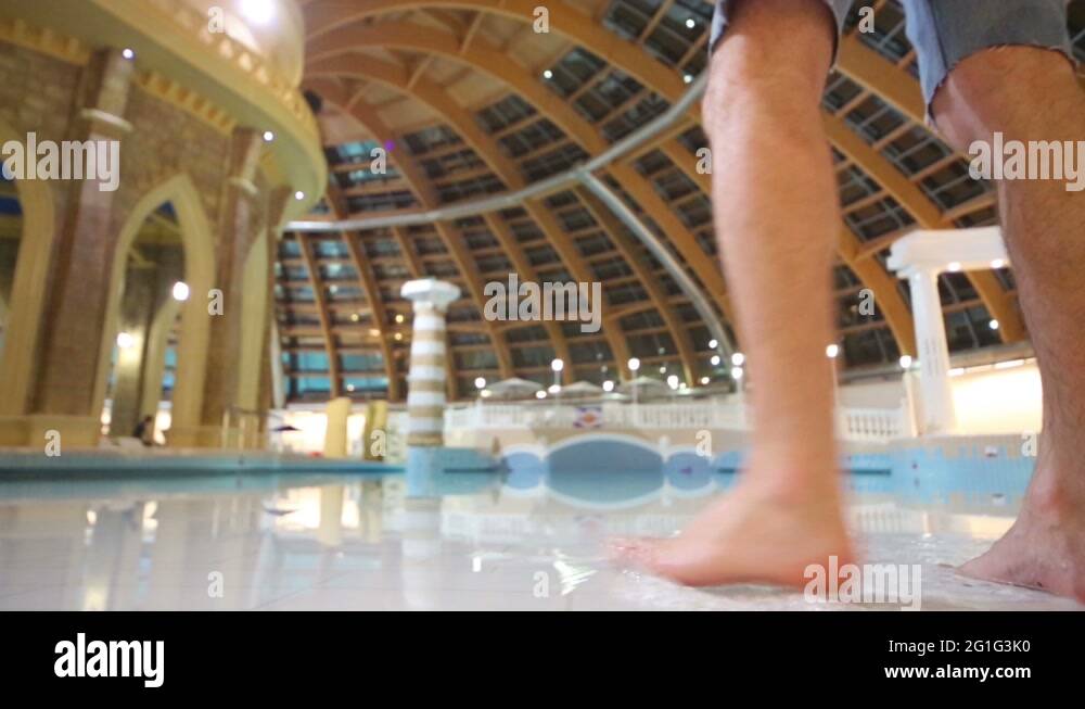 A man walks in shallow water pool at the waterpark Caribia Stock Video ...