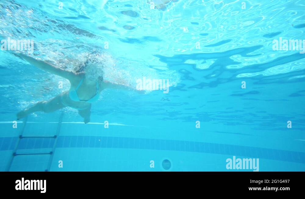 Underwater View To Diving Beautiful Girl In Blue Swimsuit Stock Video