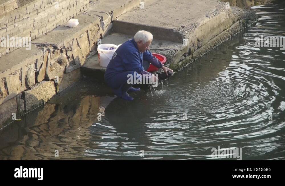 Chinese man washing clothes in Stock Videos & Footage - HD and 4K Video ...