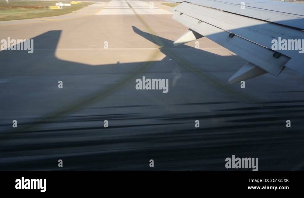 landing of an aircraft on a runway with view on airplane shadow Stock ...