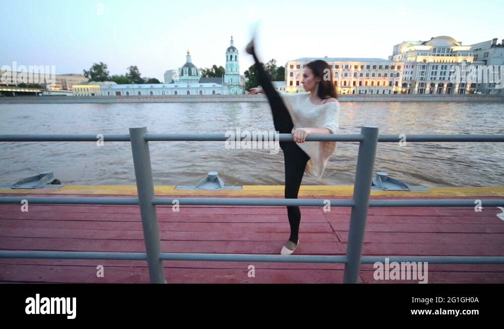 woman makes stretching exercise using as barre railing Stock Video ...